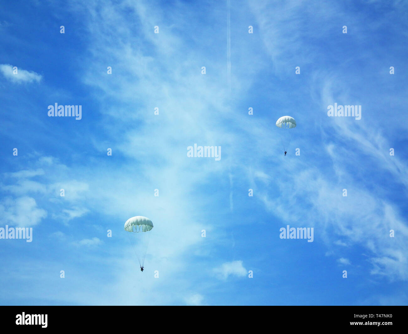 White parachutes in the blue sky Stock Photo - Alamy