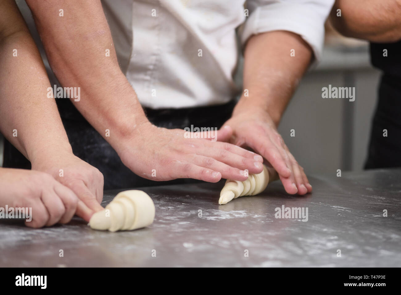 Pastry Chef rolling fresh raw croissant dough Stock Photo - Alamy