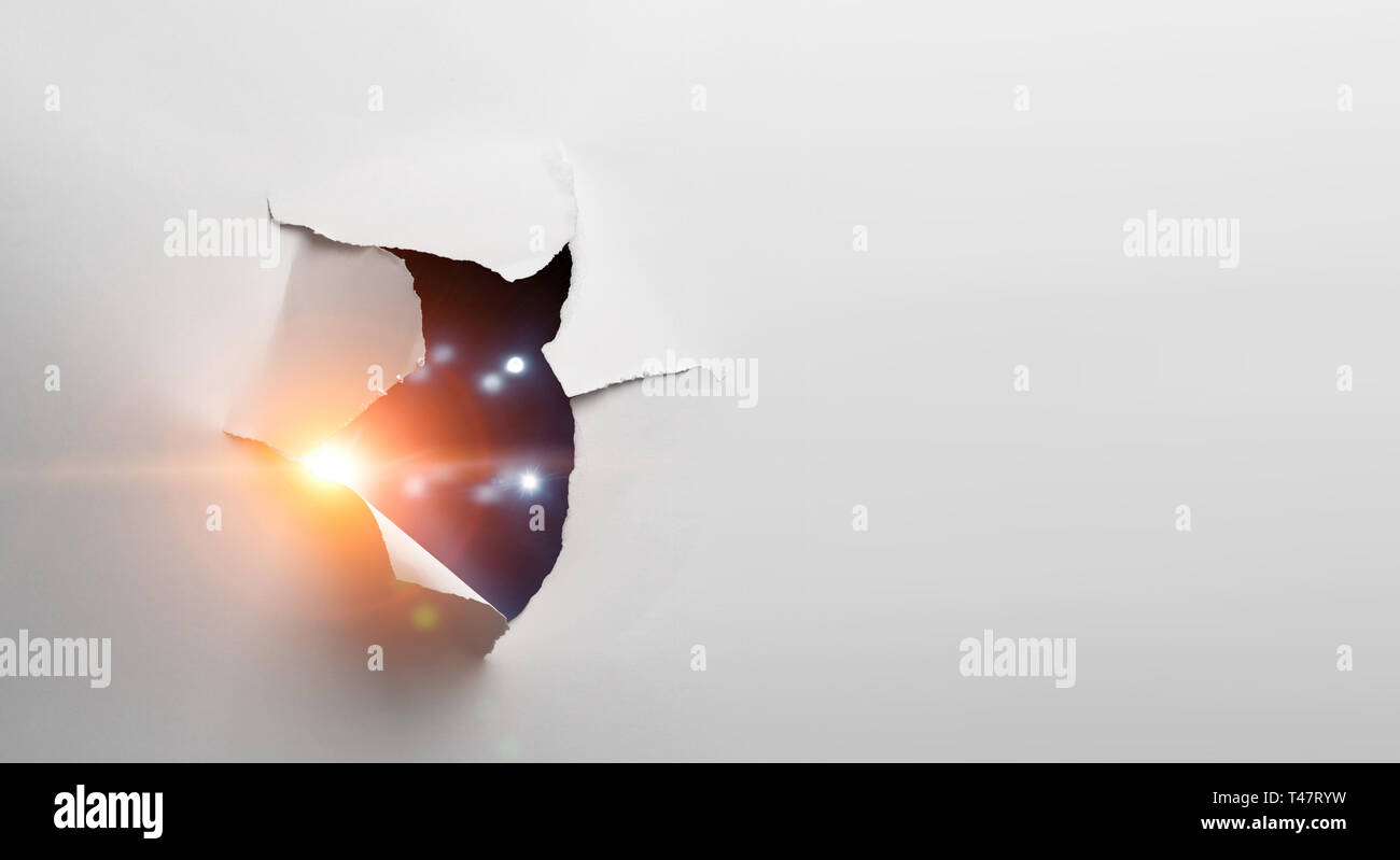 Paper torn hole effect with stadium view Stock Photo - Alamy