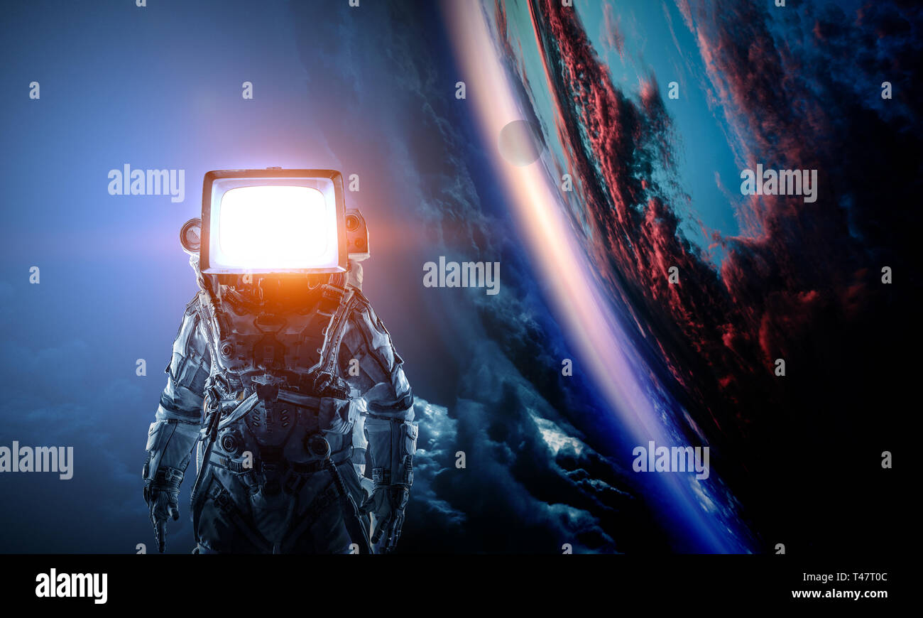Astronaut with TV head in space. Mixed media Stock Photo - Alamy