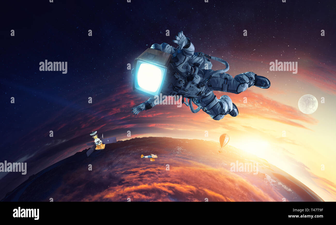 Astronaut with TV head in space. Mixed media Stock Photo - Alamy