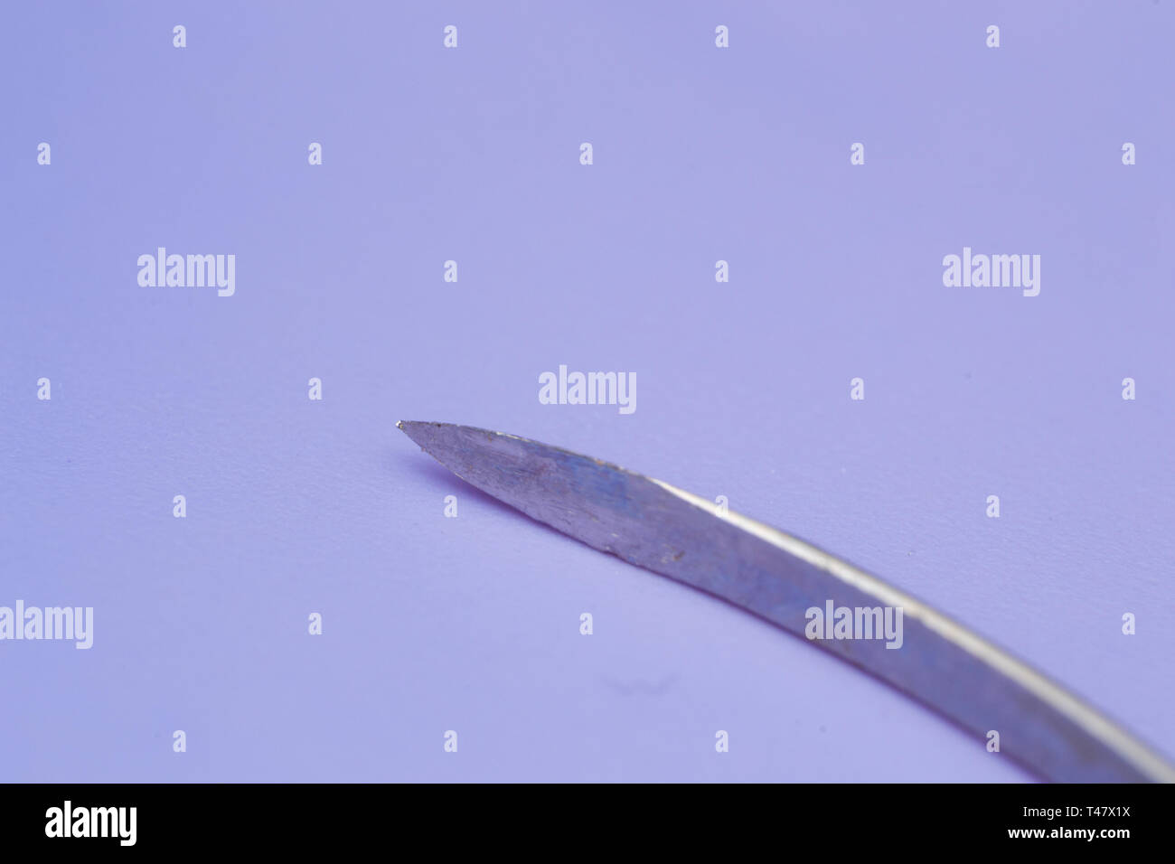 conventional cutting needle used in surgery on blue background Stock ...