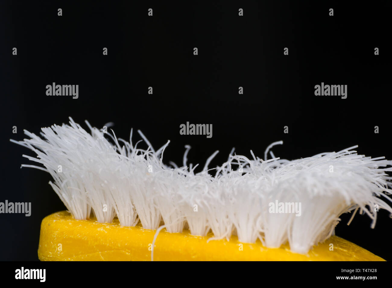 worn toothbrush closeup on black background Stock Photo - Alamy