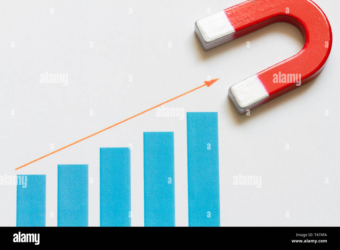 Increase business money with chart and magnet abstract Stock Photo - Alamy