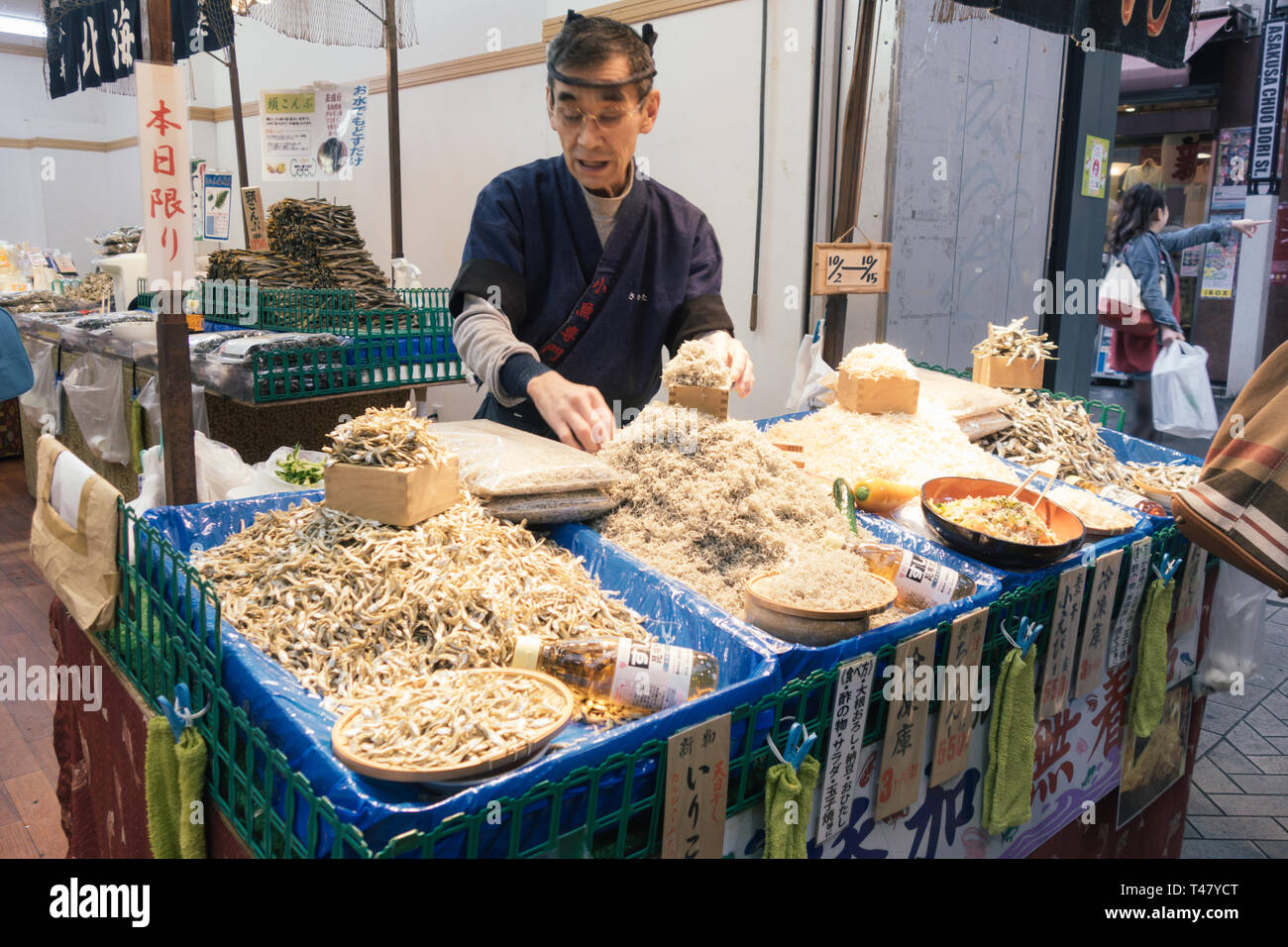 Japanese vendor in his stall, selling seafood and local food in the ...