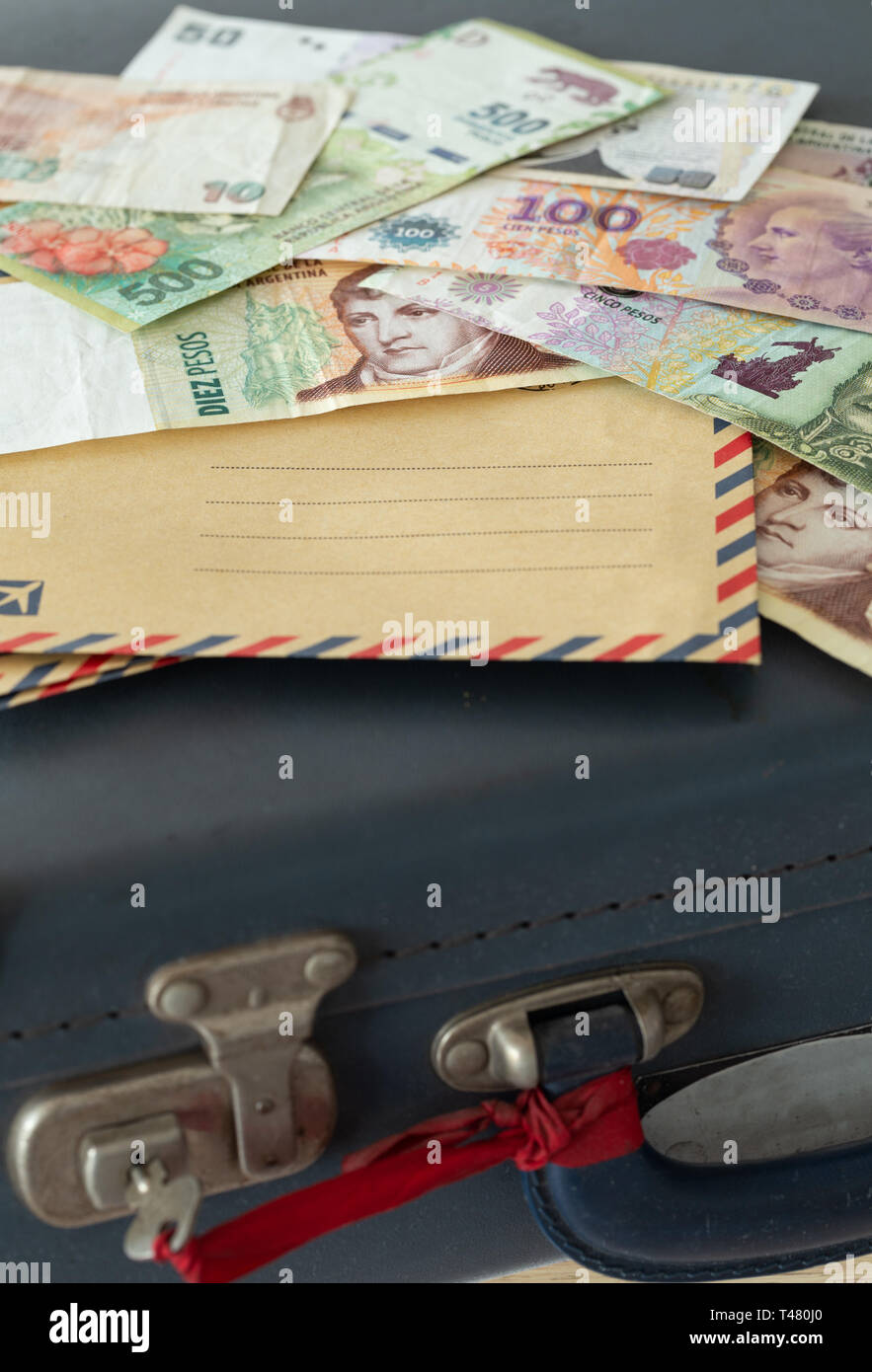old retro suitcase with Argentine money letter envelope, place for text ...