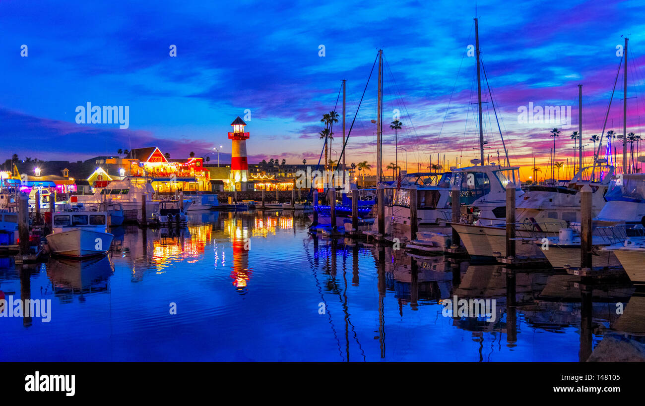 Oceanside harbor just after sunset with lighthouse and wharf lighted up ...
