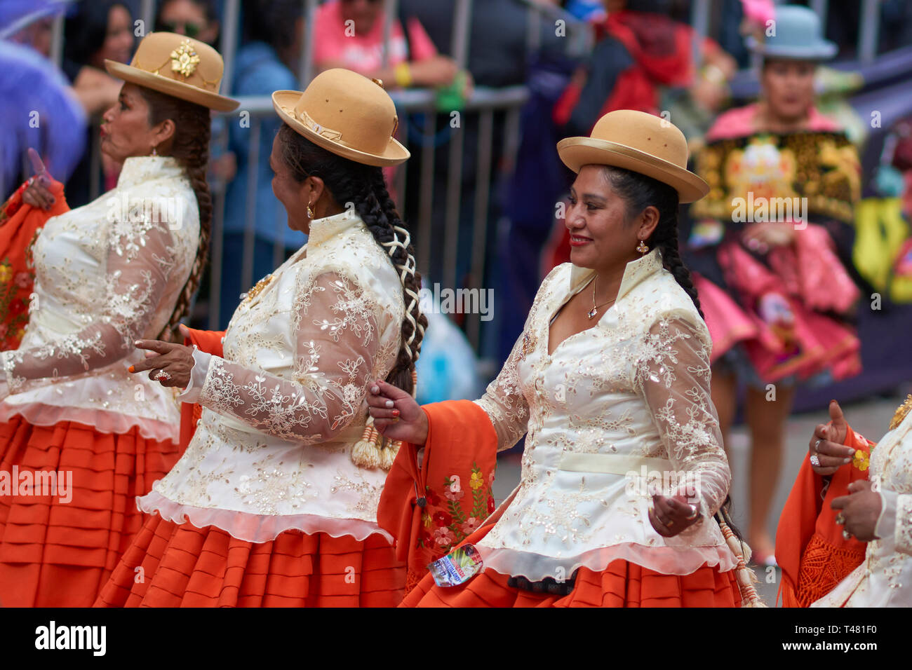 Morenada dancers in ornate costumes parading through the mining city of ...