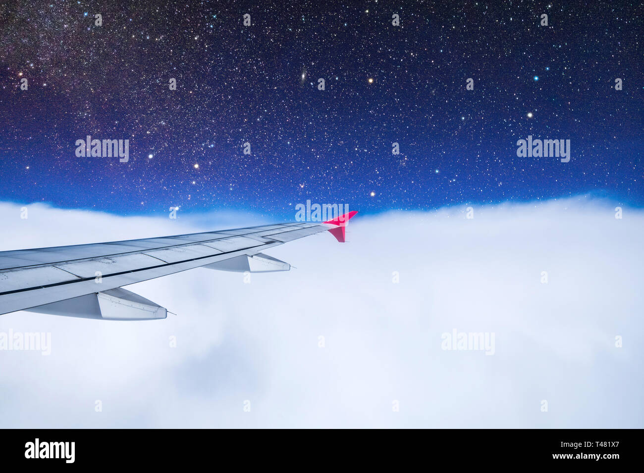 View airplane with cloudy blue stratosphere and stars Stock Photo - Alamy