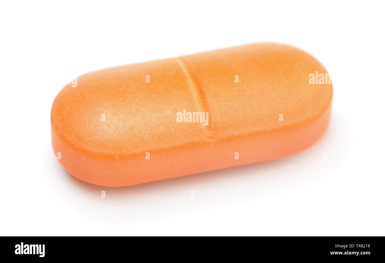 Orange pill isolated on white background Stock Photo - Alamy