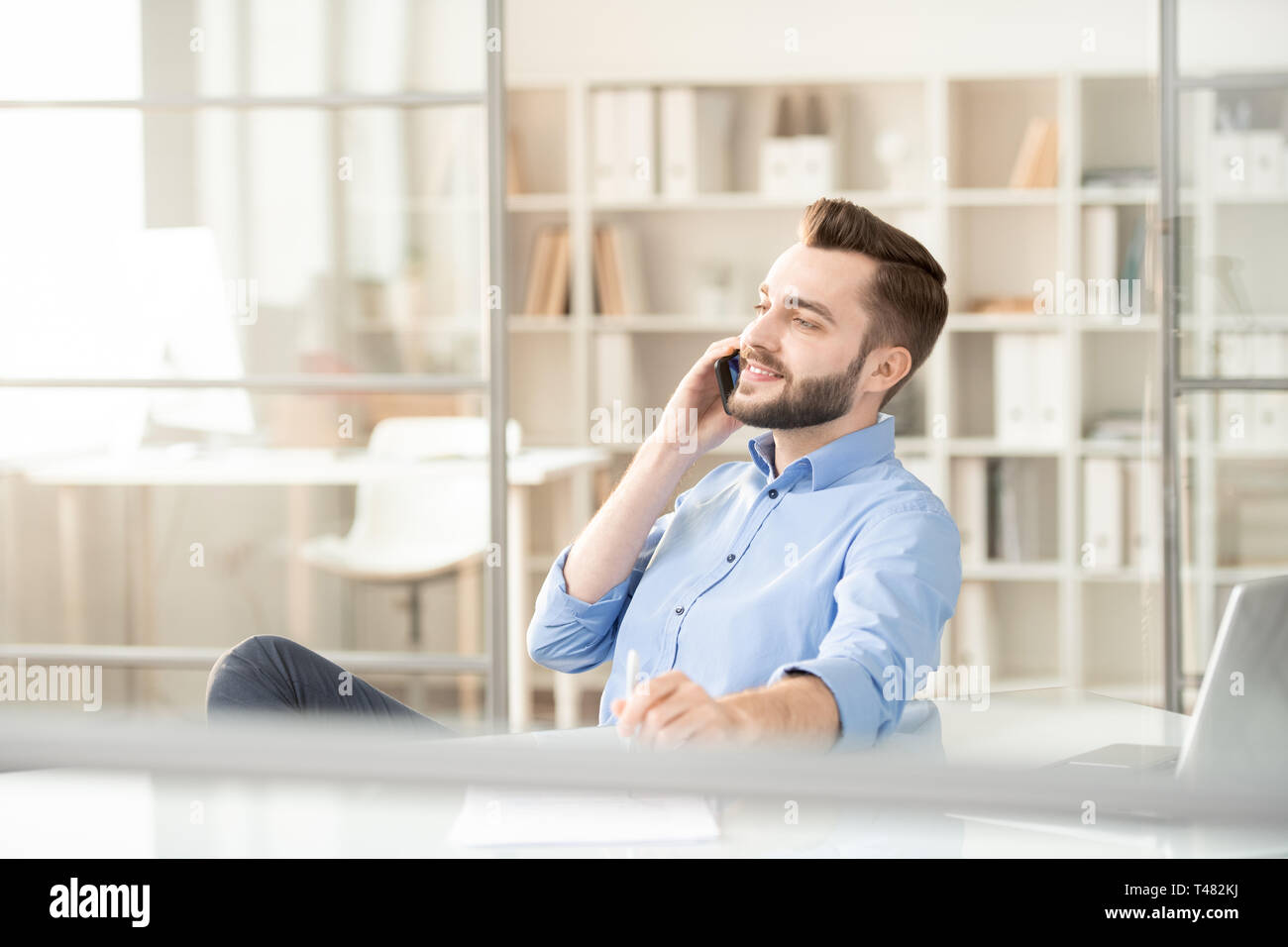 Calling client in office Stock Photo - Alamy