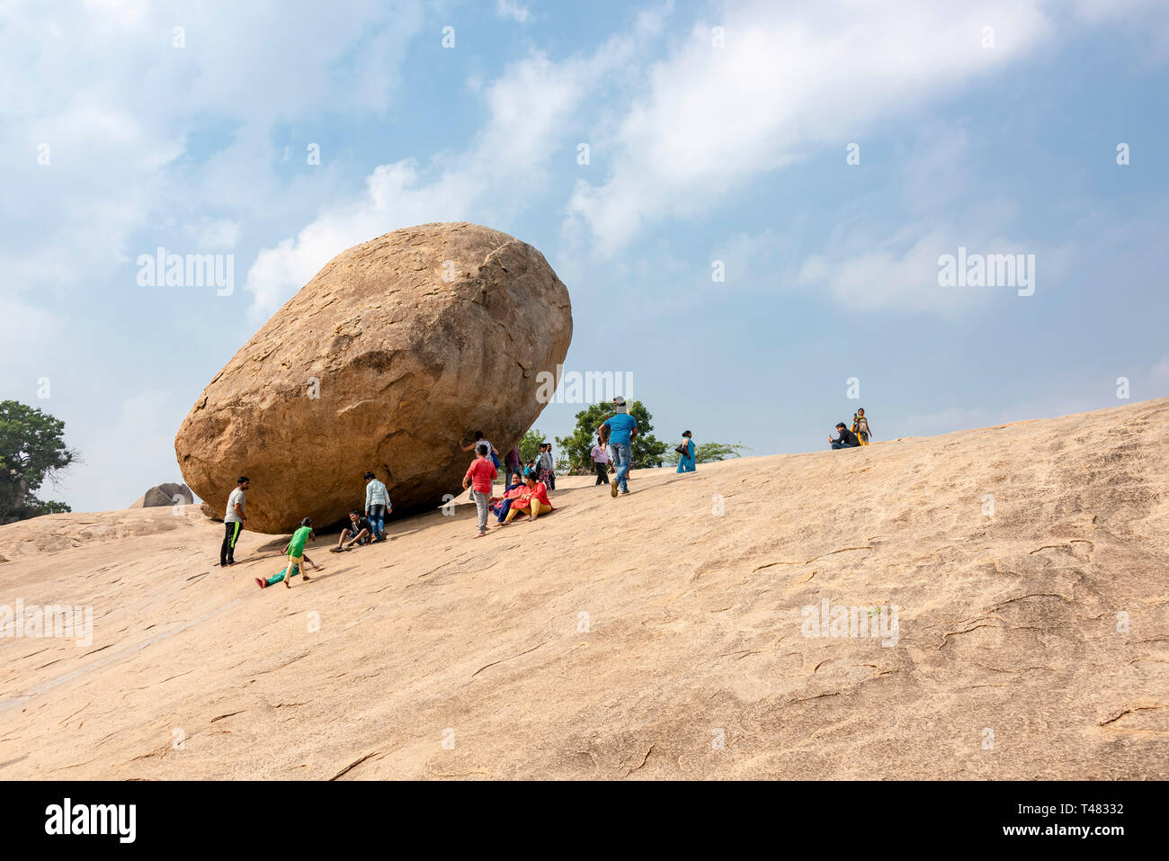 Horizontal view of children playing next to Krishna's Butterball at ...