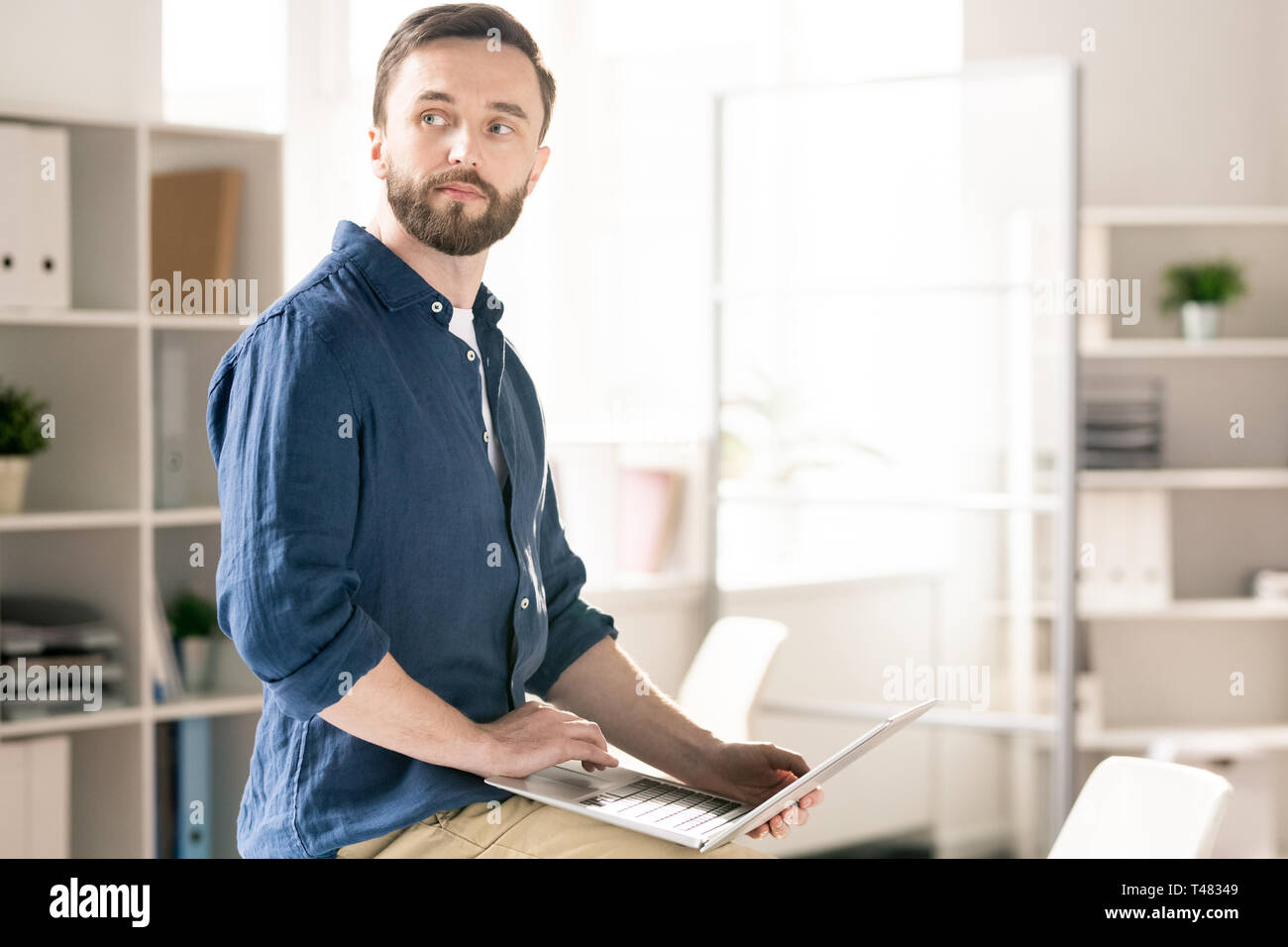 Employee with laptop Stock Photo - Alamy
