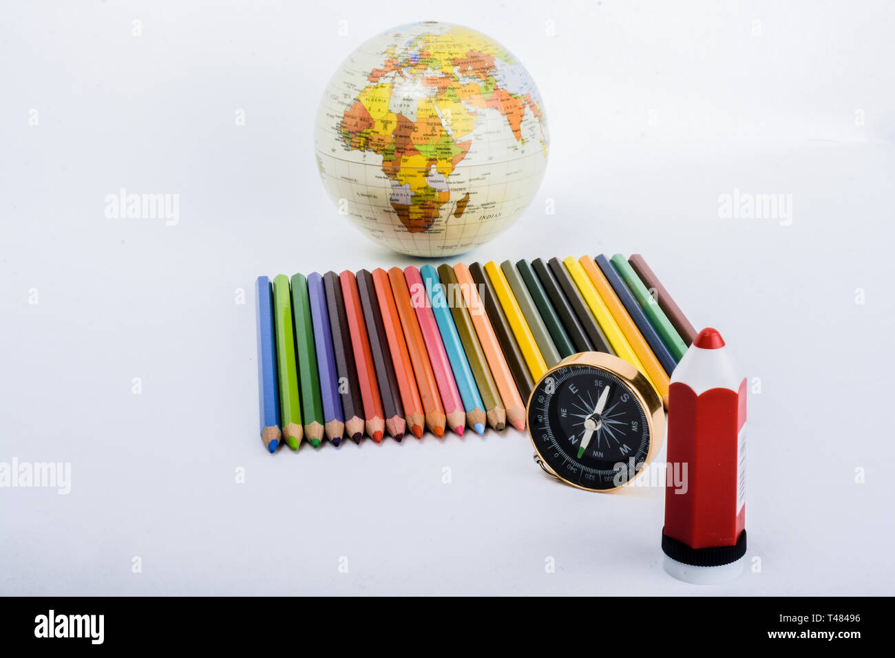 Colour pencil with compass, pen and a globe on white background Stock ...