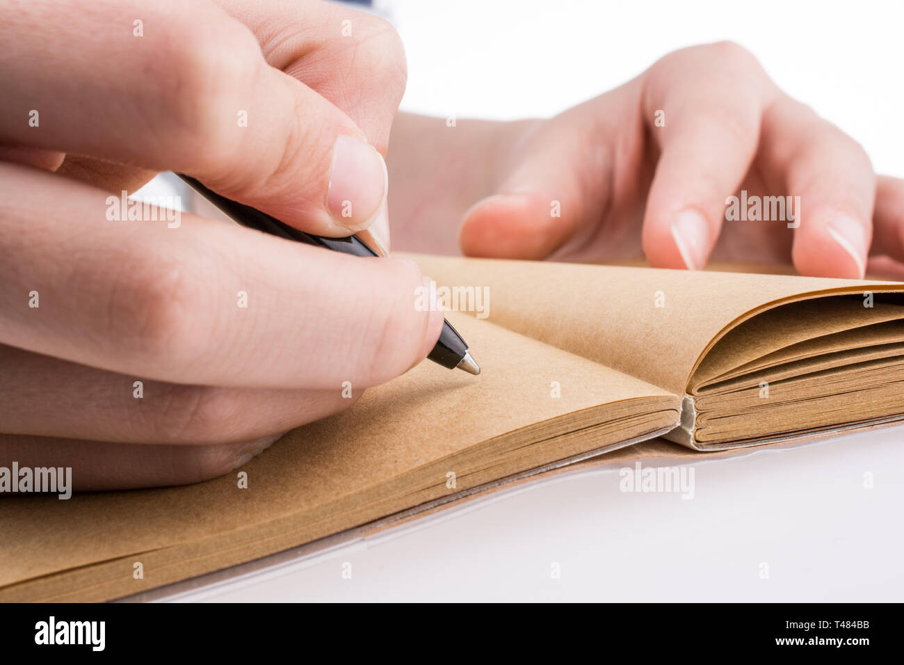 Hand writing on a notebook with a pen Stock Photo - Alamy