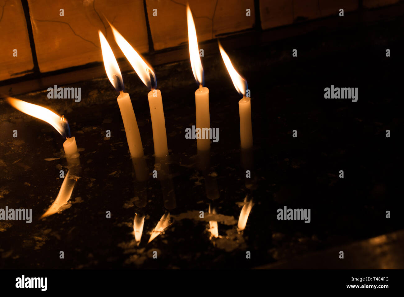 Burning candles with candle light in the dark Stock Photo - Alamy
