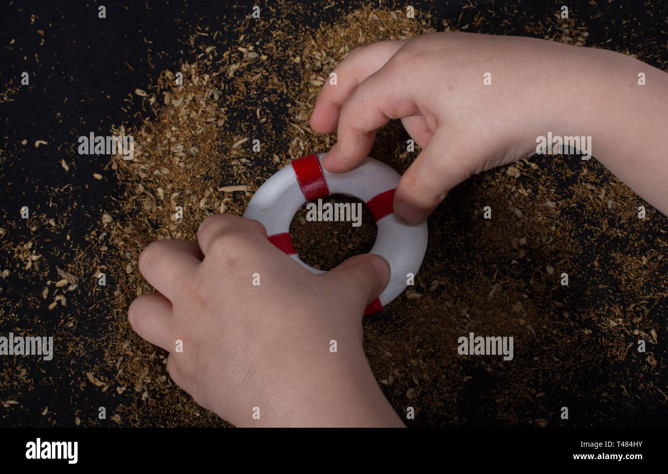Little model life preserver is being held in hand Stock Photo - Alamy