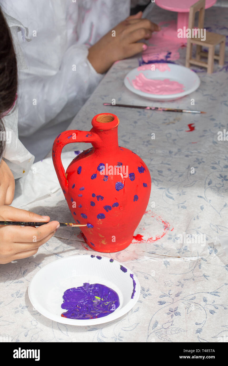 Young children decorating their handmade clay pottery Stock Photo - Alamy