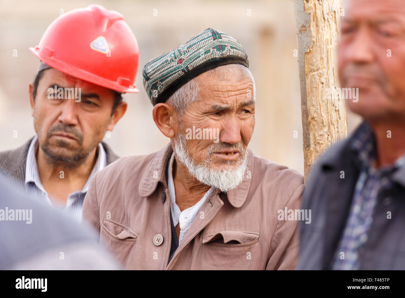 Portrait of an elderly Uyghur man wearing a doppa (traditional hat ...