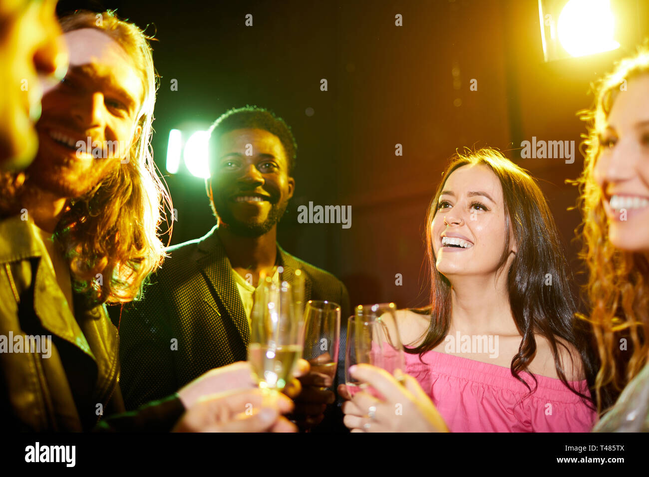 Positive friends talking in nightclub Stock Photo - Alamy