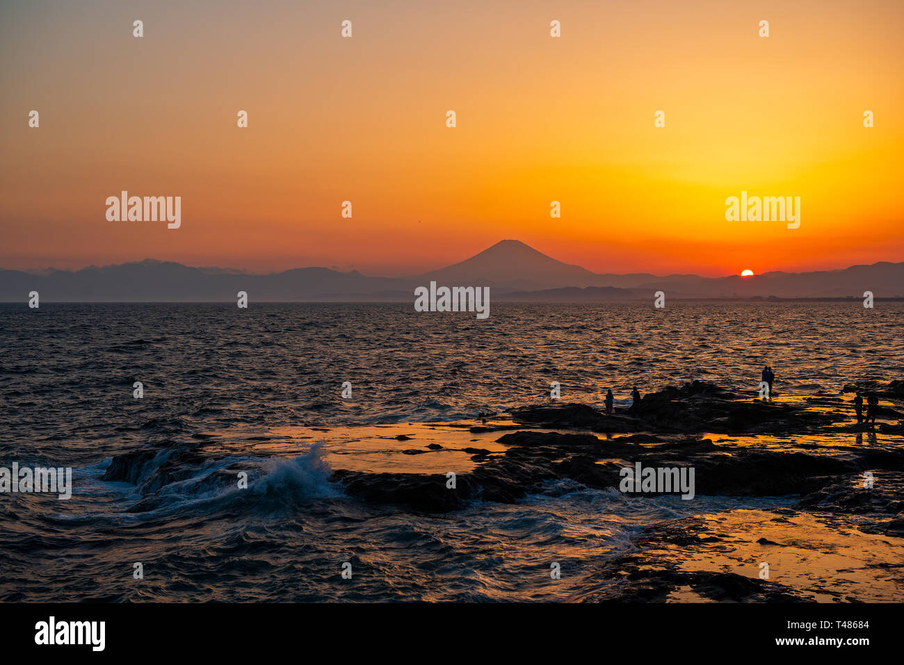 The sun setting near Mt. Fuji as seen from Enoshima, Japan Stock Photo ...