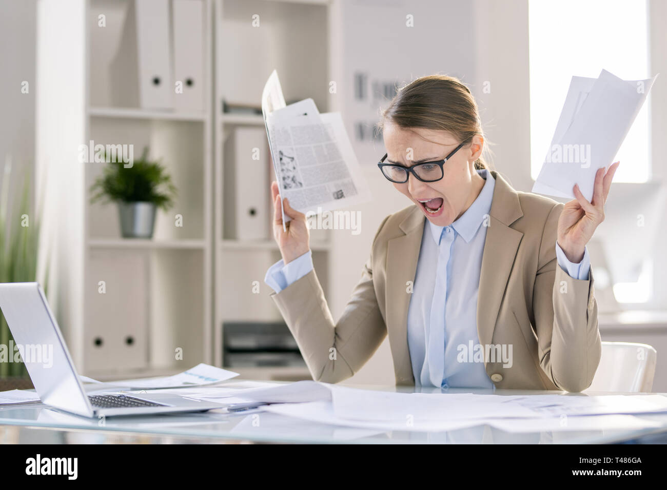 Young businesswoman checking papers hi-res stock photography and images - Alamy