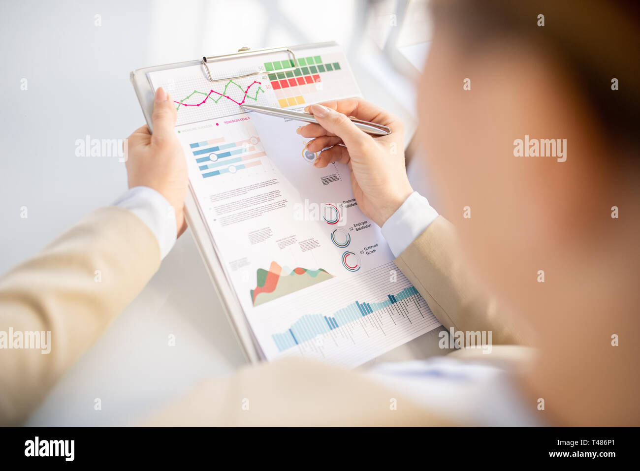 Examining graph in report Stock Photo - Alamy