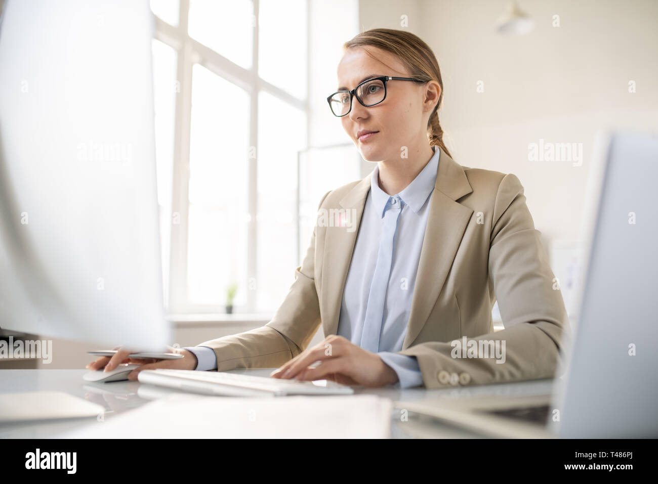 Serious office manager using computer Stock Photo - Alamy