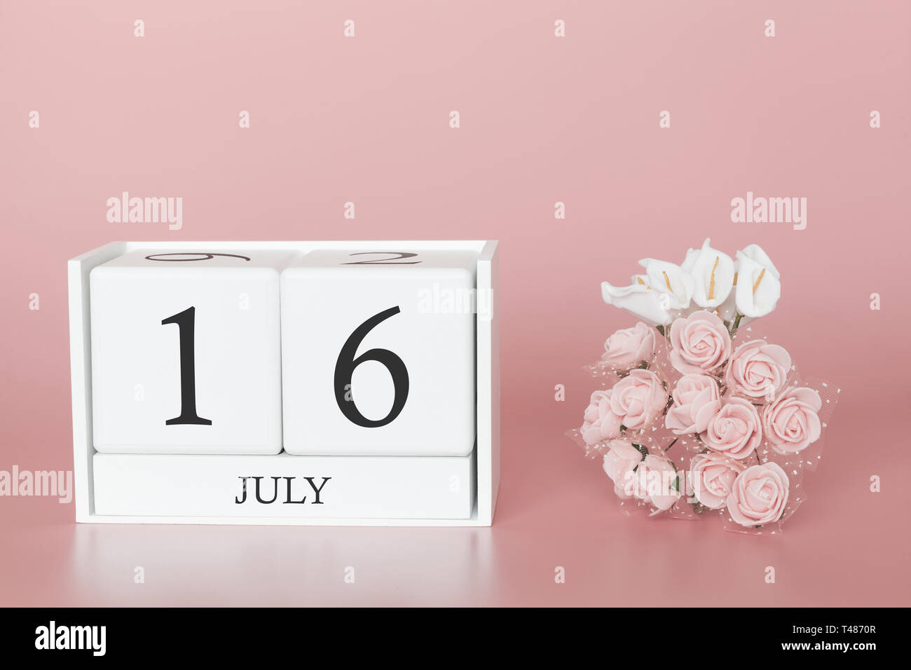 July 16th. Day 16 of month. Calendar cube on modern pink background ...