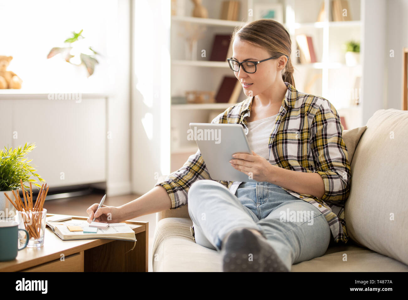 Student girl working on project at home Stock Photo - Alamy