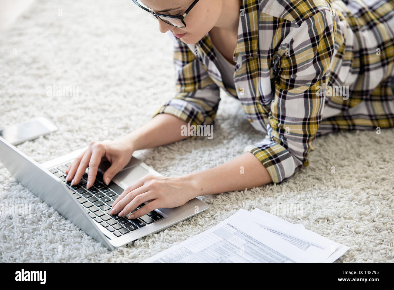 Busy woman entering data into laptop Stock Photo - Alamy