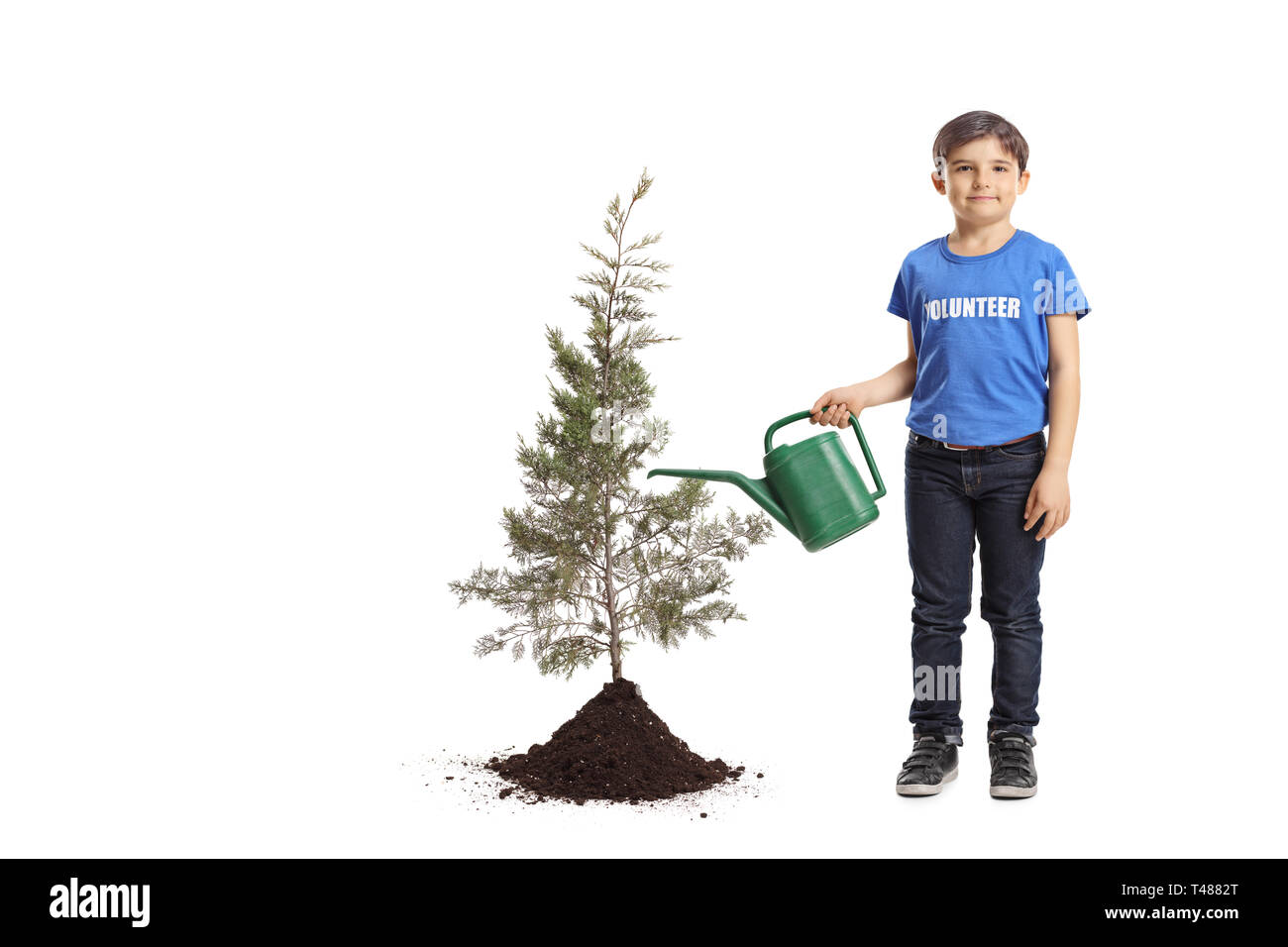 Full length portrait of a boy volunteer pouring water to a planted tree ...