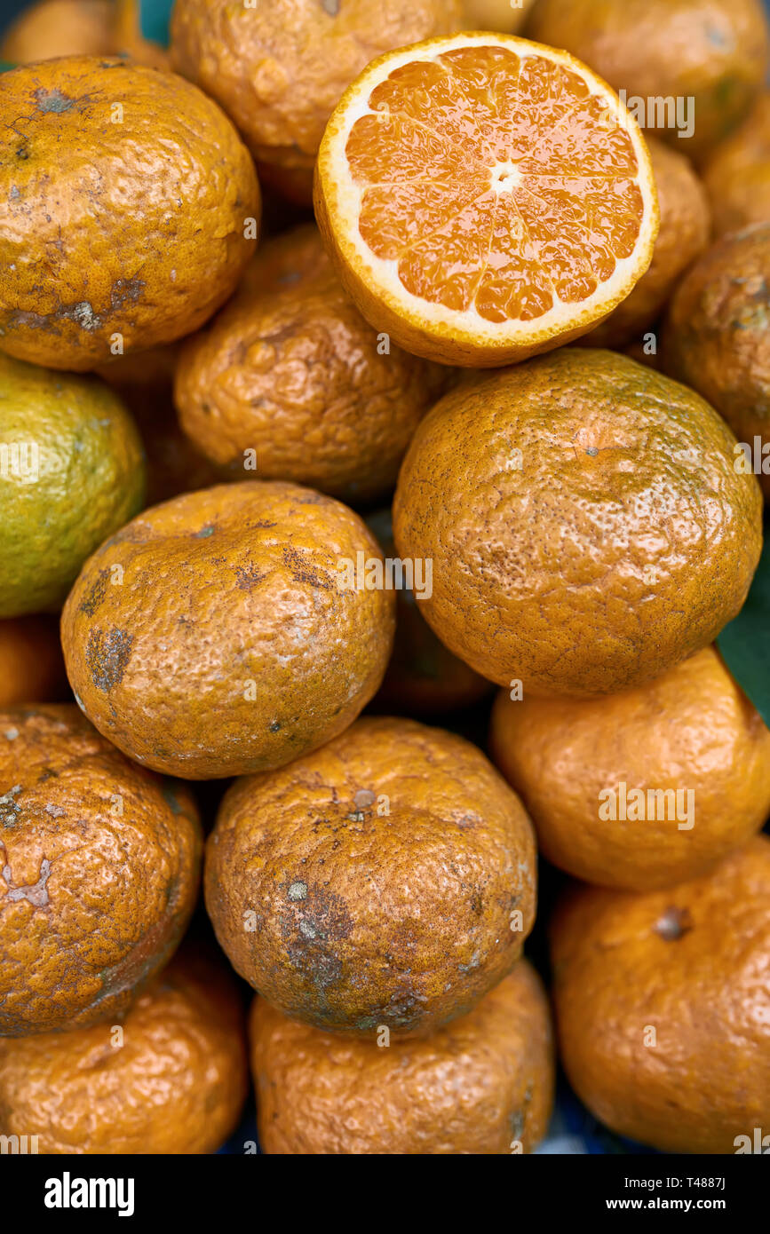 Ripe sliced citrus lying on pile of oranges Stock Photo - Alamy