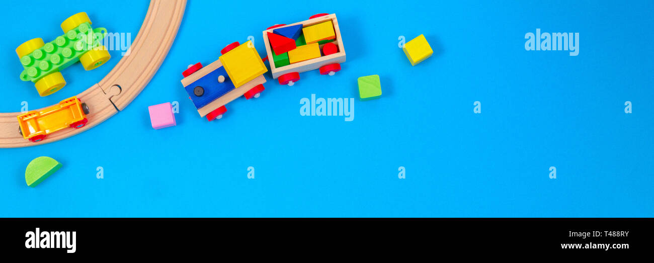 Baby kid toy background. Wooden toy train with colorful blocks on blue ...