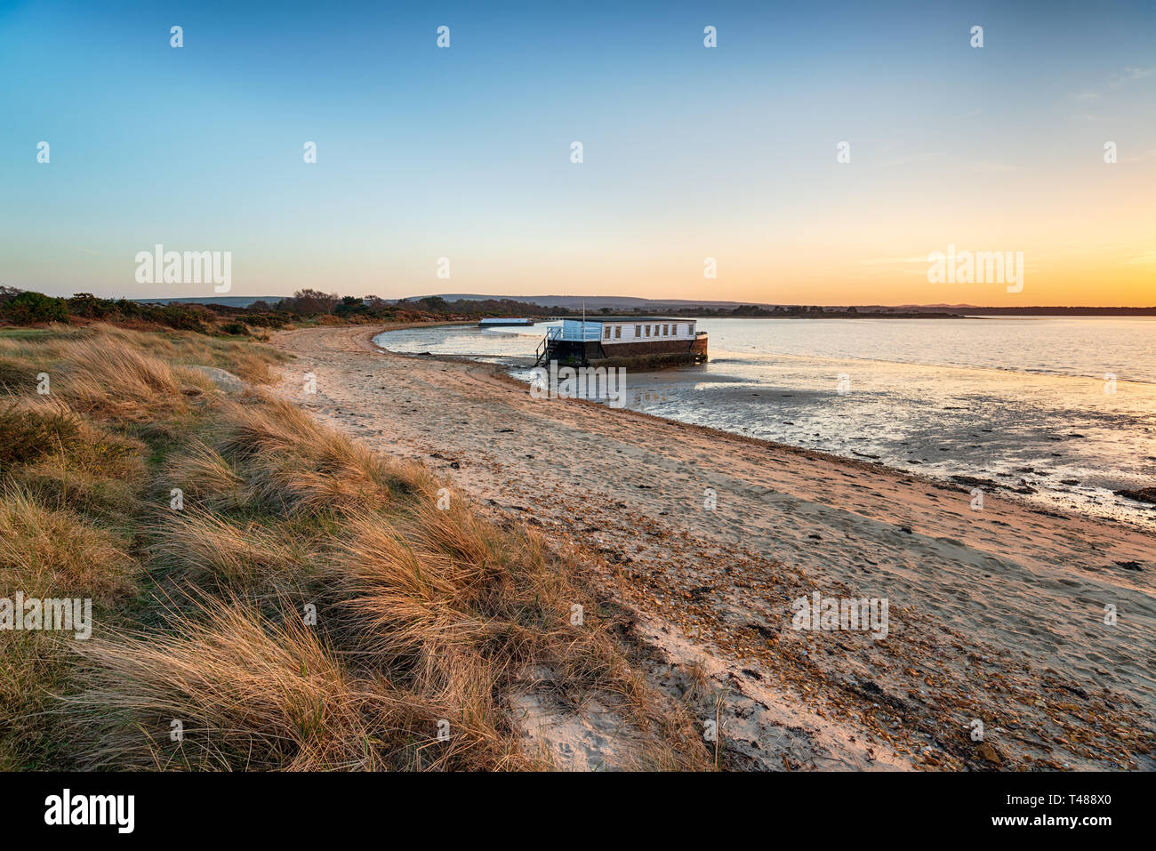 Sunset over the beach at Bramble Bush Bay on the Studland peninsula in ...
