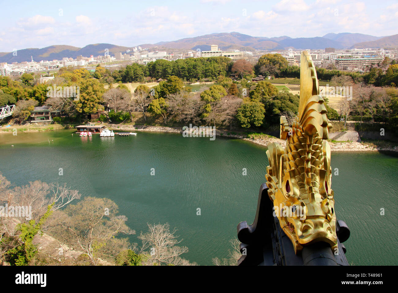 Gold Japanese fish statue on top of Okayama castle and river view in ...