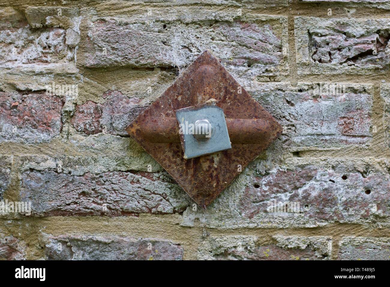 Metal support attached to brick wall Stock Photo - Alamy