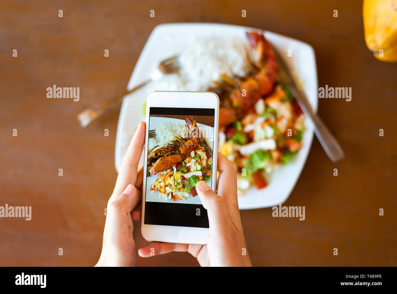 Girl taking photo of seafood in a restaurant first person view Stock ...