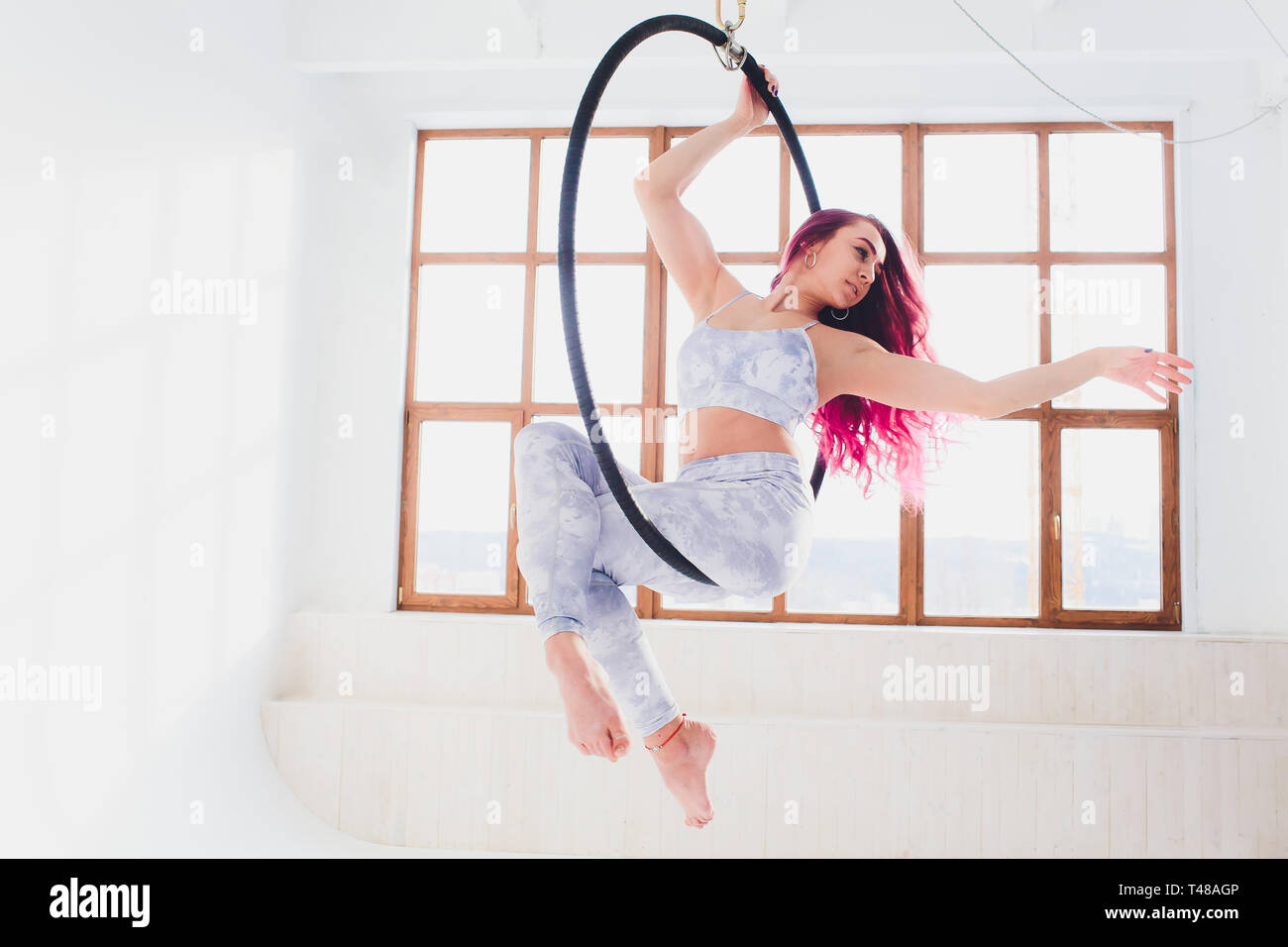 Aerial acrobat in the ring. A young girl performs the acrobatic ...