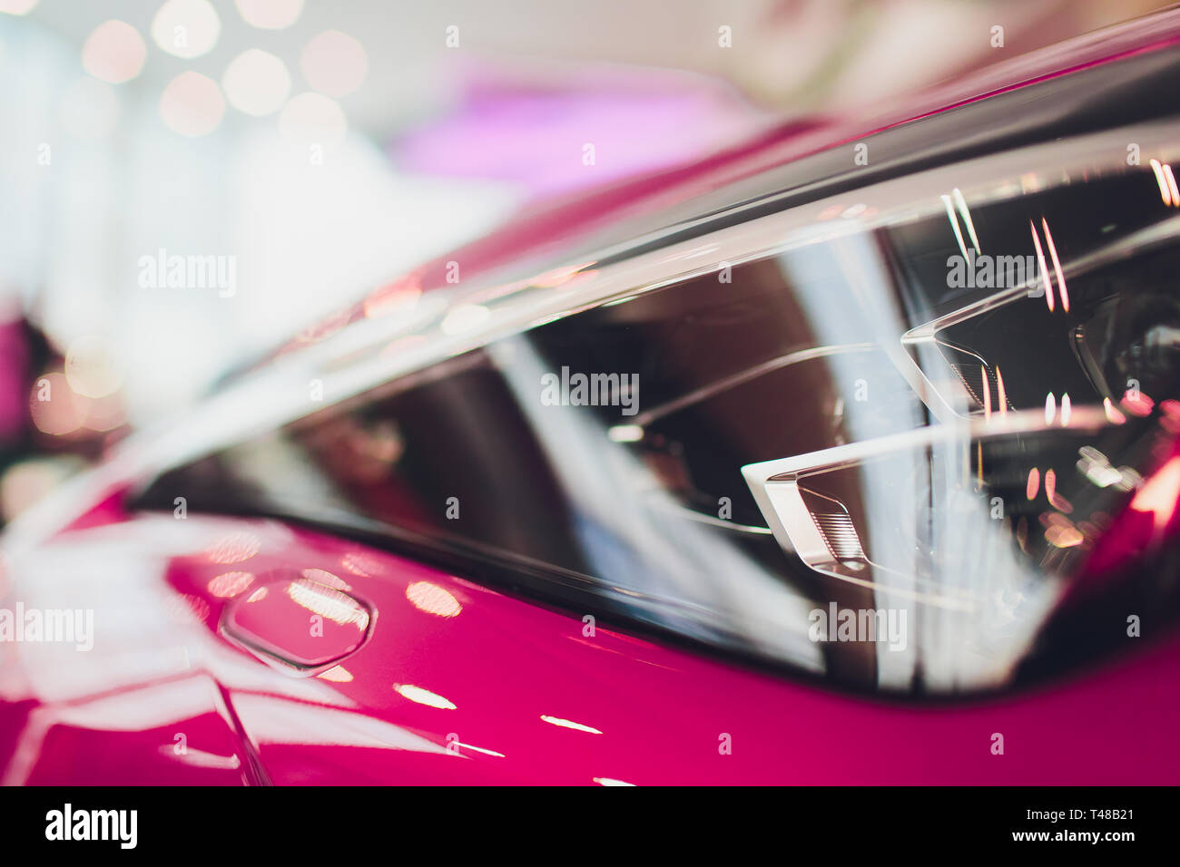 Close up shot headlight in luxury pink car background. Modern and ...