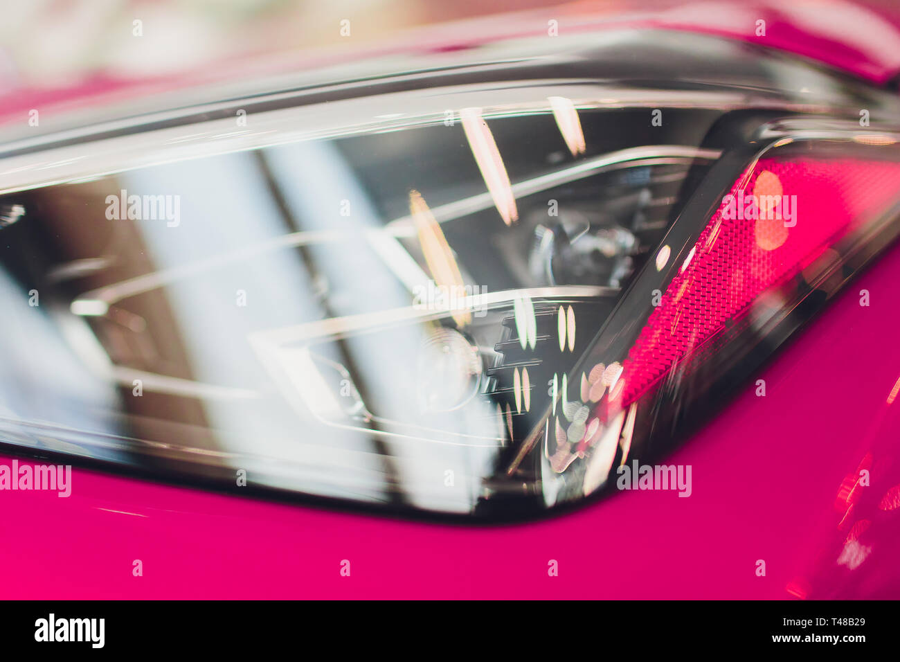 Close up shot headlight in luxury pink car background. Modern and ...