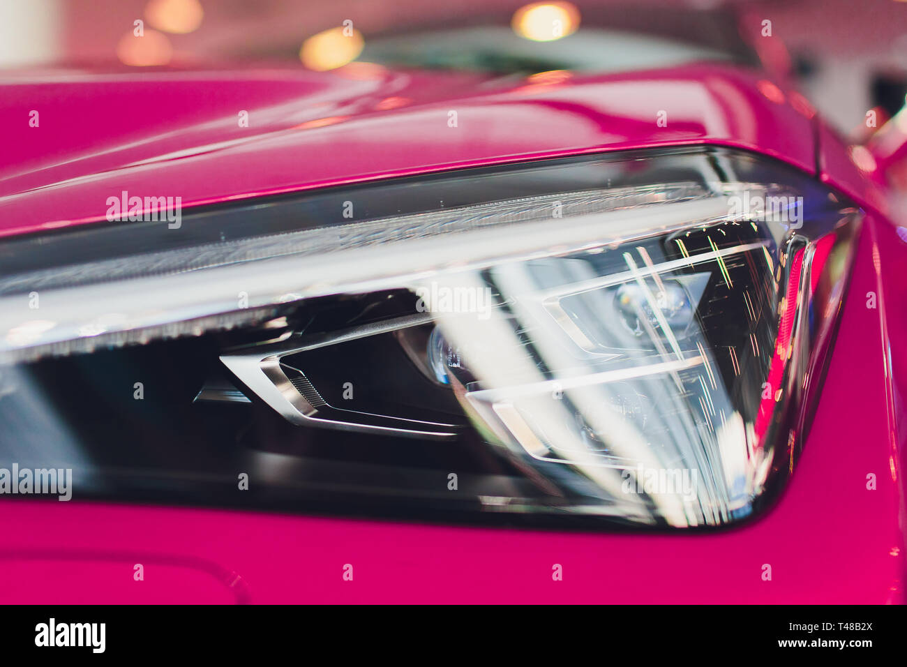 Close up shot headlight in luxury pink car background. Modern and ...