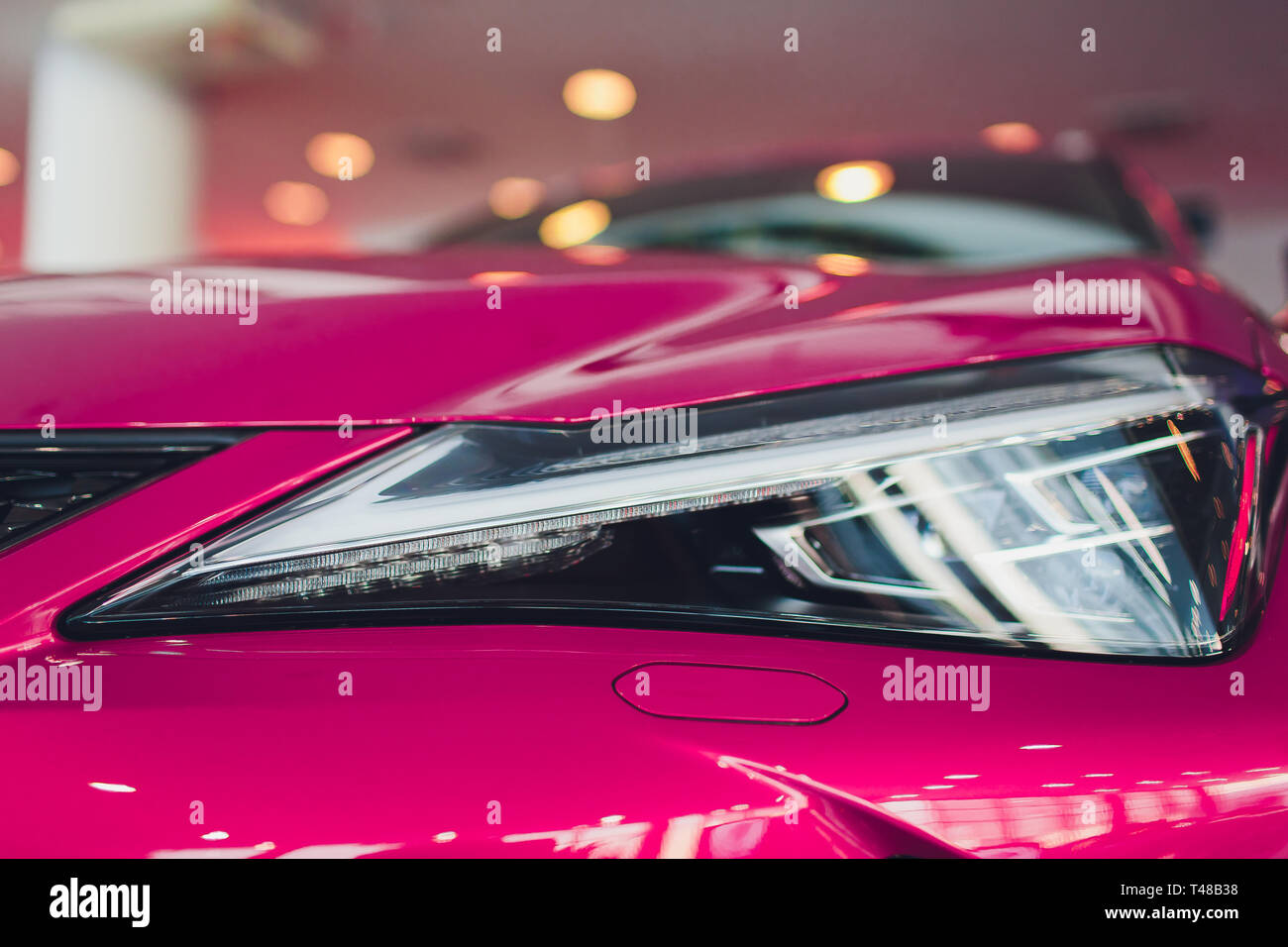 Close up shot headlight in luxury pink car background. Modern and ...