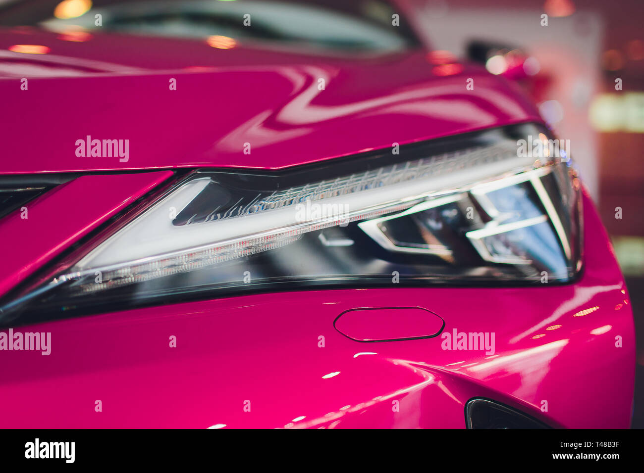 Close up shot headlight in luxury pink car background. Modern and ...
