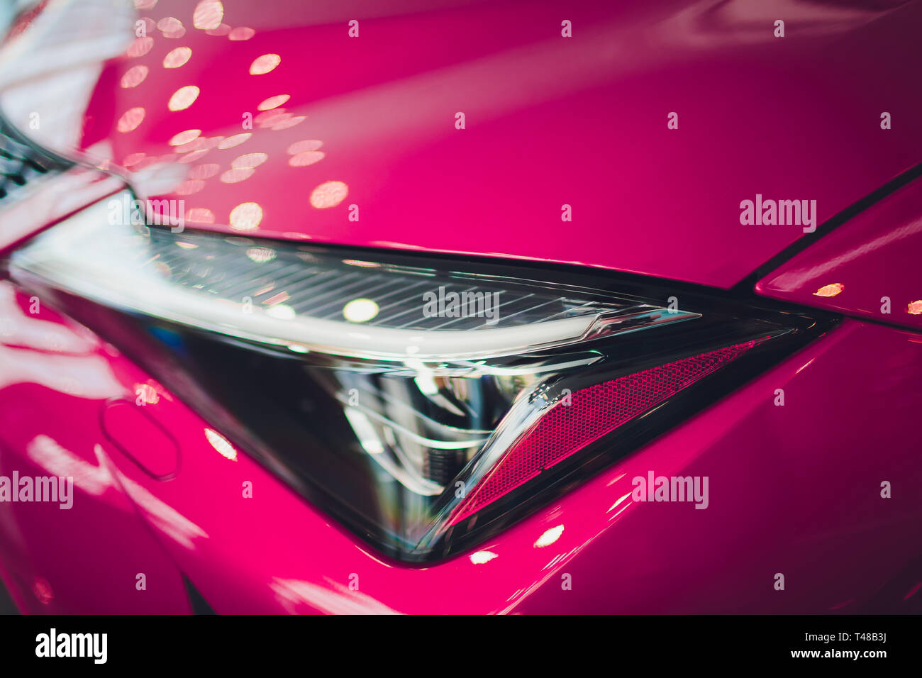 Close up shot headlight in luxury pink car background. Modern and ...