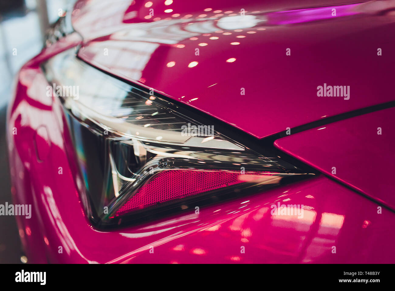 Close up shot headlight in luxury pink car background. Modern and ...