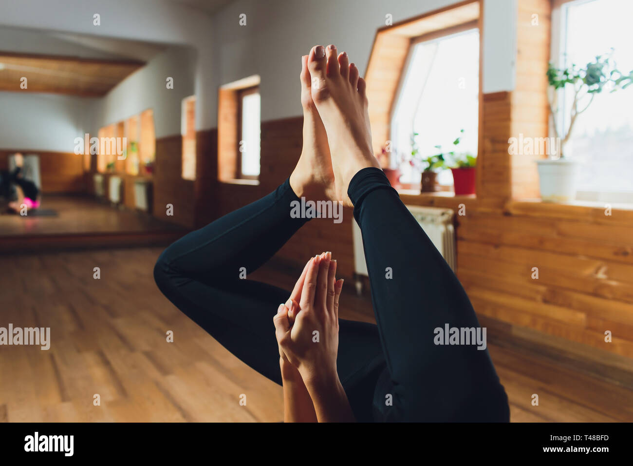 Young sporty woman practicing yoga, doing Alternate Nostril Breathing ...