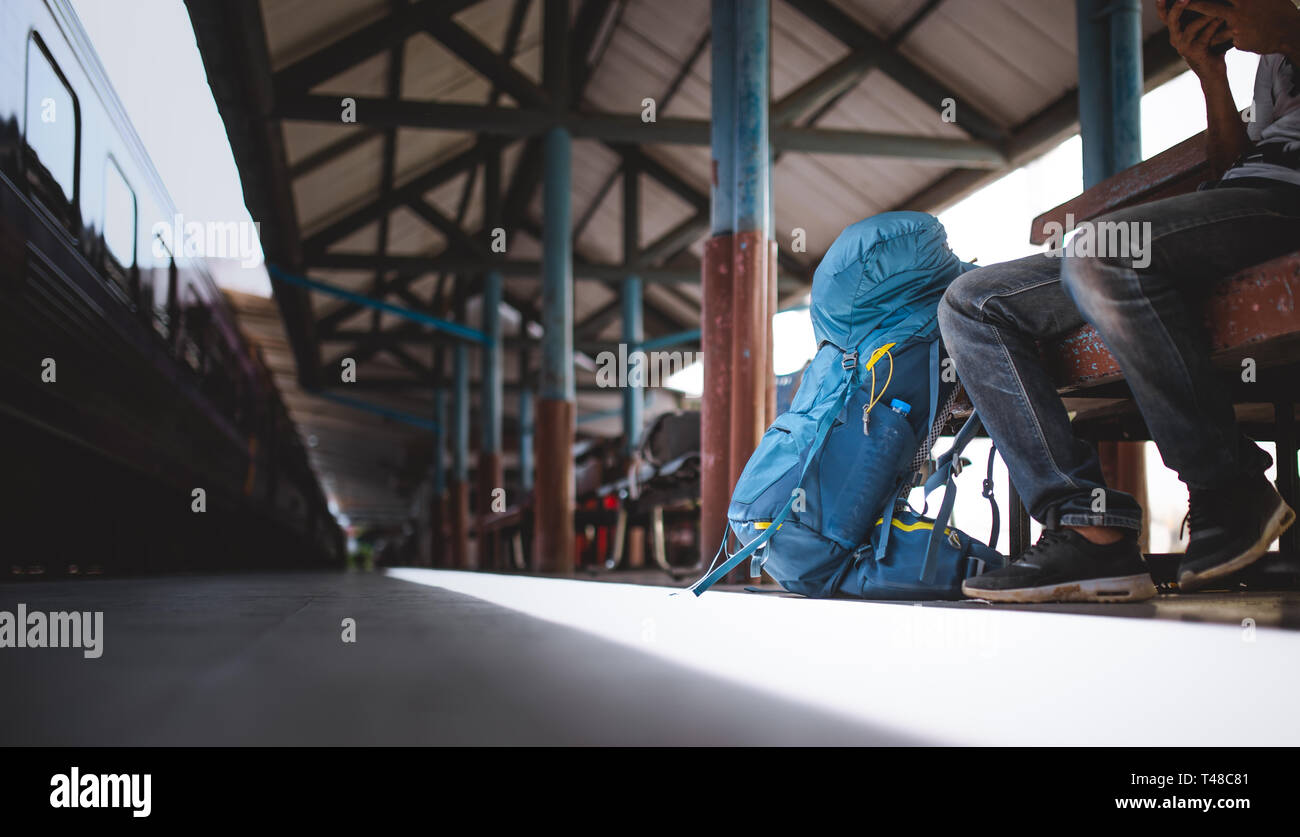 Traveler are backpacking and sitting alone at train station Stock Photo ...