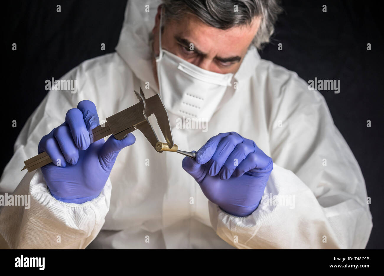 Expert Police measures bullet caliber in ballistic lab, conceptual ...