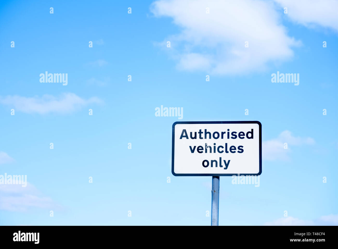 Authorised vehicles only sign against blue sky Stock Photo - Alamy